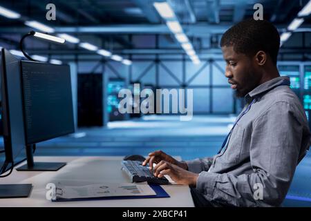 Worker checking for signs of imminent failure in data center establishment gear. Indian woman ...