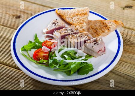 Deliciously lightly fried tuna with toasted bread, served with greens ...