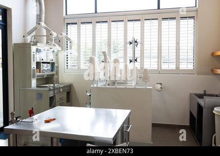 Modern prosthetic lab with various prosthetic limbs displayed on ...