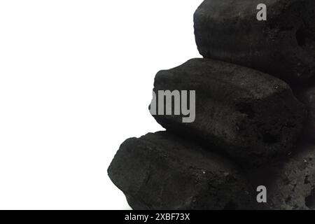 pile of hexagonal charcoal briquettes isolated on a white background ...