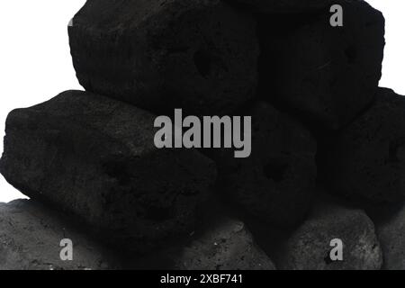 pile of hexagonal charcoal briquettes isolated on a white background ...