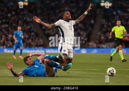 Daniel Leo Gretarsson of Iceland tackling Ivan Toney of England in the ...