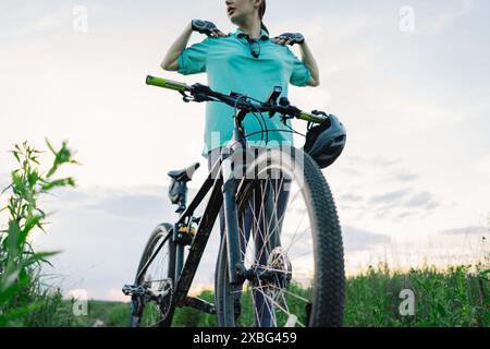 Woman Stretching Before Bike Ride in Green Field Stock Photo - Alamy
