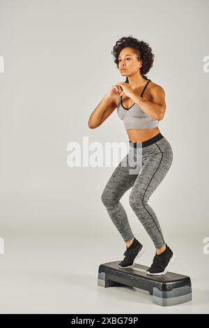 Sporty young woman training with stepper in gym Stock Photo - Alamy