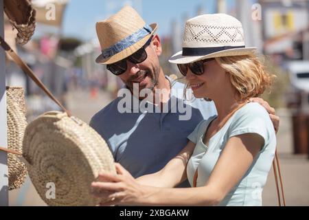 Adult female shopper choosing handbag in clothing store Stock Photo - Alamy