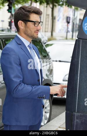Man pays for parking with a credit card with NFS technology. Easy ...