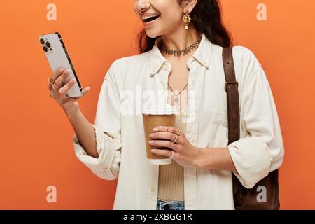 indian woman multitasking with coffee and phone in hand Stock Photo - Alamy