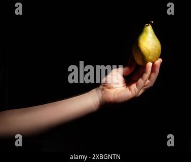 Hand holding whole pear isolated on white background Stock Photo - Alamy