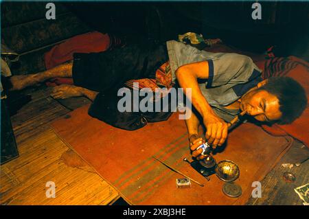 Chasing the dragon, opium addict. Hmong village, Chiang Rai province ...