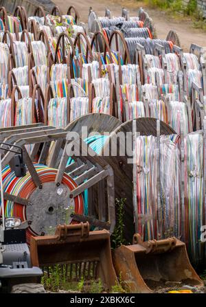 Cable drums with conduits for fiber optic cables, at a storage yard ...
