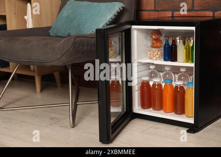 Mini refrigerator with drinks and snacks indoors Stock Photo - Alamy