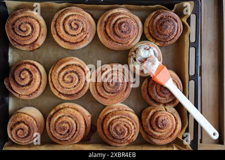 preparing homemade round cinnamon scrolls with sugar crystals in a ...