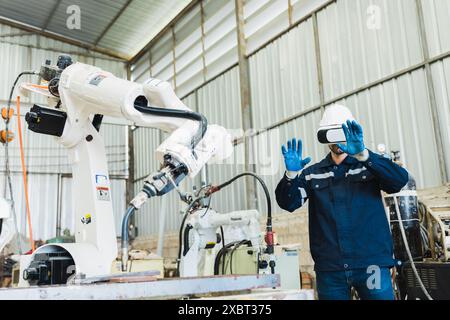 engineer using vr Glasses for controlling the robotic welding arm in ...