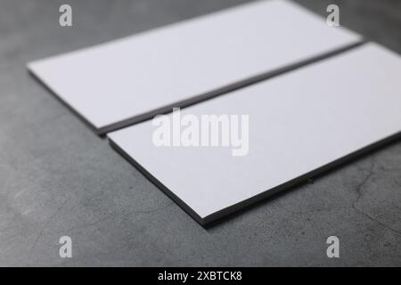 Blank business cards on grey textured background, closeup. Mockup for ...
