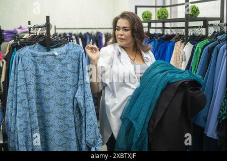 A fat woman chooses clothes in a plus size store Stock Photo - Alamy
