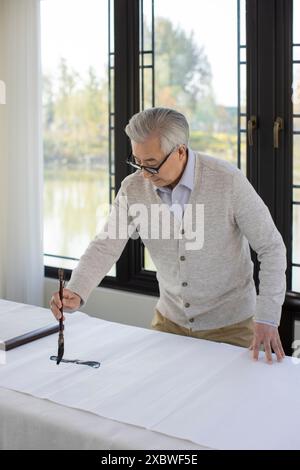 Senior Man Practicing Chinese Calligraphy Stock Photo - Alamy
