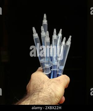 Teeth whitening equipment and syringes on a white surface Stock Photo ...
