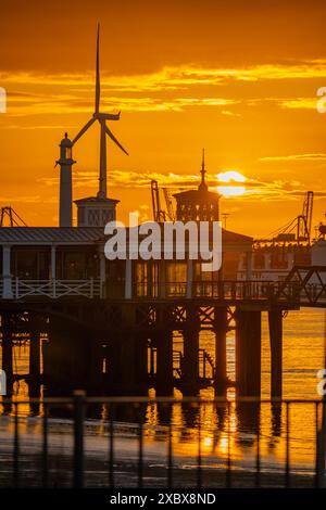 Gravesend town pier at Gravesend Kent at sunset with the docks at ...