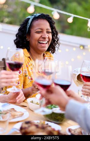 Young latin woman in a red dress going down the stairs of a building ...