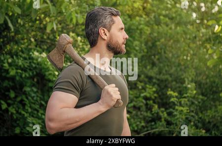 man hold axe wearing shirt. man with axe outdoor. photo of man with axe ...