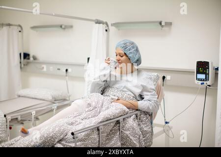 Young patient recovering after surgery in post operative care room in ...