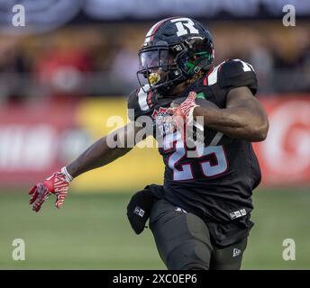 Ottawa Redblacks' Ryquell Armstead (25) is tackled by Edmonton Elks' Nick Anderson (48) during ...