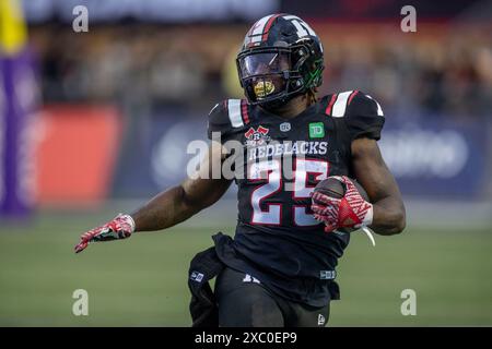 Ottawa Redblacks' Ryquell Armstead (25) is tackled by Edmonton Elks ...