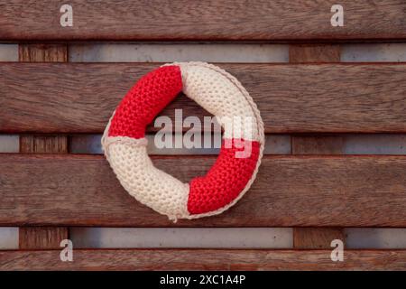 Handmade small crocheted toy lifebelt on the wood Stock Photo - Alamy