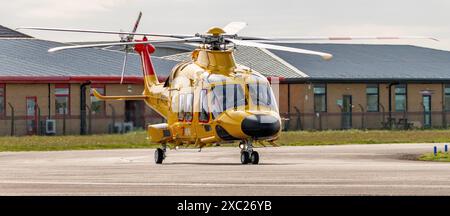 Yellow NHV helicopter with black nose taxiing at Blackpool Airport ...