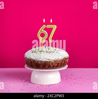 Pink number 67 birthday candle on white background Stock Photo - Alamy