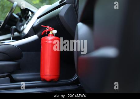 Red fire extinguisher in automobile. Car safety equipment Stock Photo ...