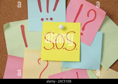 Notes with word SOS and symbols on board, closeup Stock Photo - Alamy