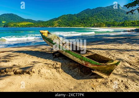Primitive wooden fishing canoe on the sands of Castelhanos beach in ...