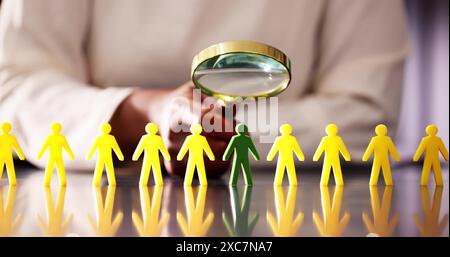 African American woman using a magnifying glass to select diverse ...