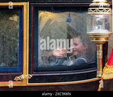 The Princess of Wales waving to the crowds as she is escorted by ...