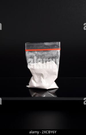 Cocaine in plastic packet isolated on black background. illustration of ...