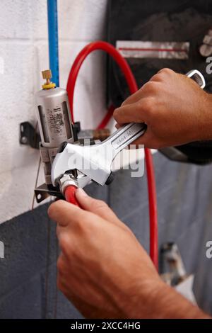 Worker using adjustable spanner in car repair shop Stock Photo - Alamy