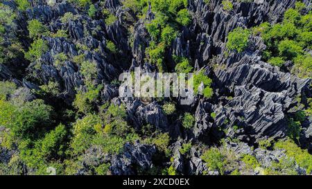 Karst mountain in Maros in aerial drone view with mount Bawakaraeng in ...