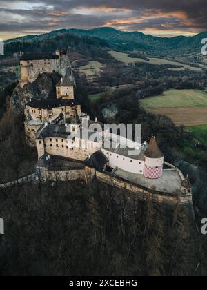 Aerial panoramic view of medieval Orava Castle on high rock with forest ...