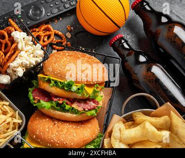 Selection of party food for watching football championship on a dark ...