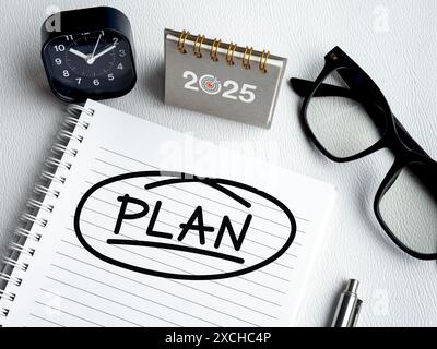 Notepad with text 2025 My Goals, on wooden surface. Priorities and ...