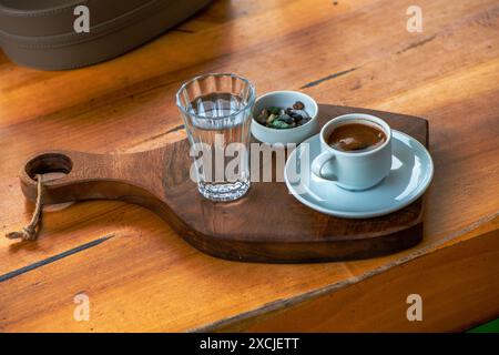 Turkish coffee presentation with pebble chocolate and a glass of water ...