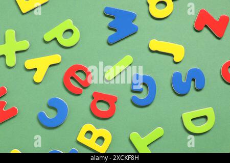 Learning alphabet. Magnetic letters on yellow background, flat lay ...