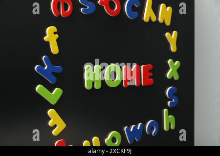 Word Home and frame made of many bright magnetic letters on fridge ...