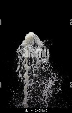 Water exploding into the air with a black background, vertical Stock ...