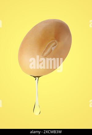 Cooking oil dripping from soybean on yellow background Stock Photo - Alamy
