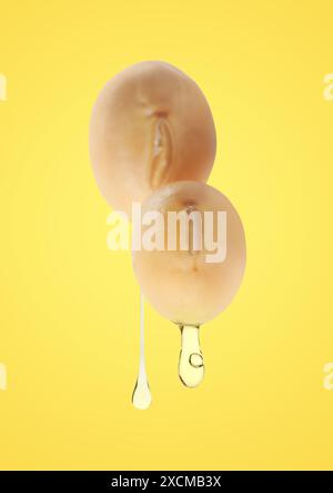 Cooking oil dripping from soybeans on yellow background Stock Photo - Alamy