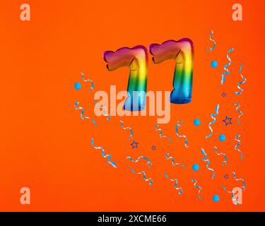 Air balloon number 77 - Birthday cake on blue background Stock Photo ...