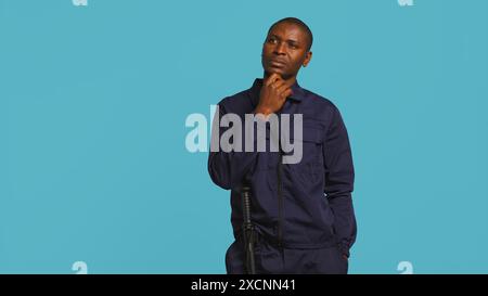 Security guard doing thinking hand gesture during surveillance shift ...