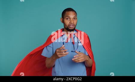 Male nurse portraying superhero showing courage and strength fighting ...